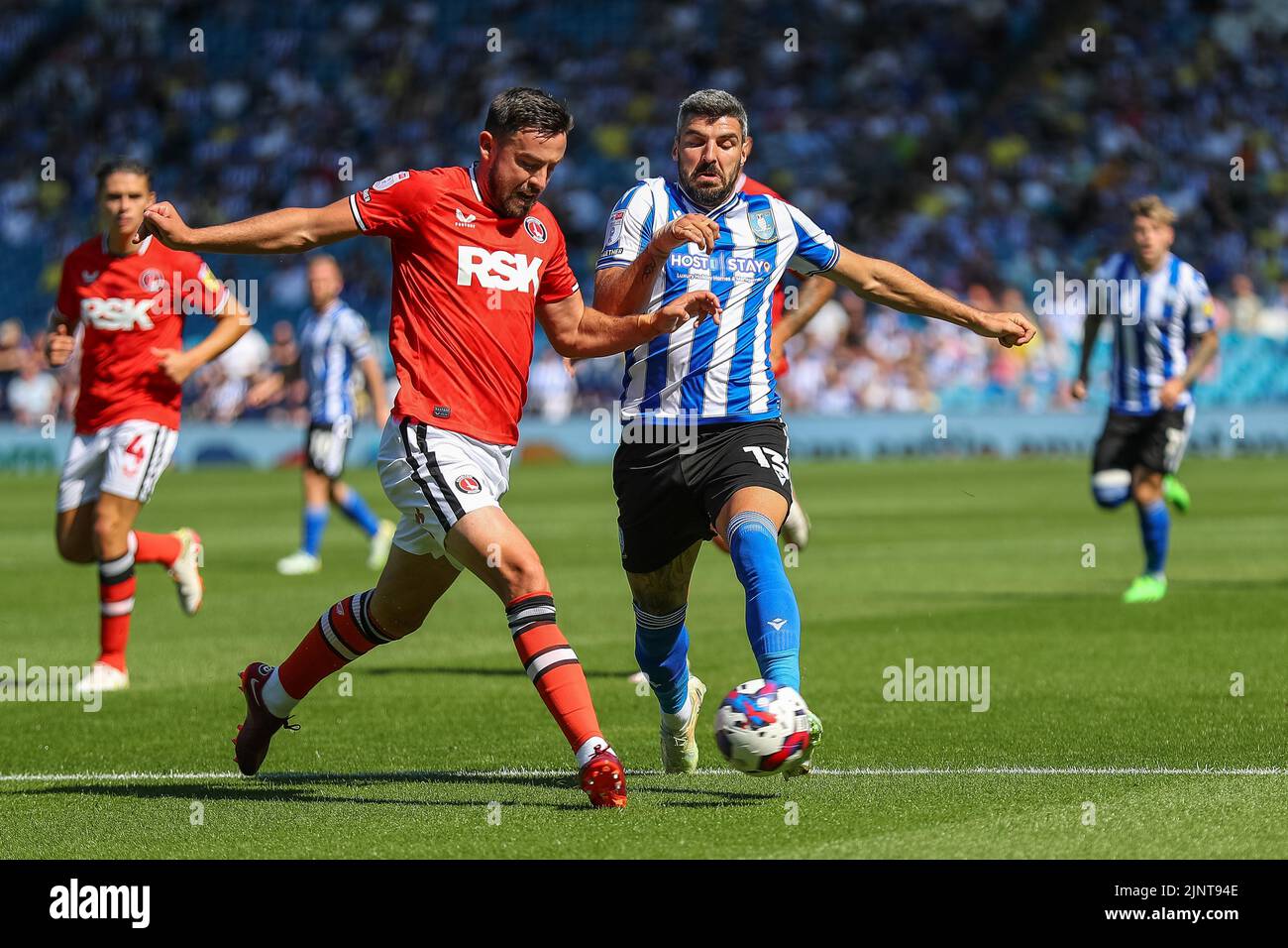 Eoghan O'Connell #6 of Charlton Athletic tackles Callum Paterson #13 of ...