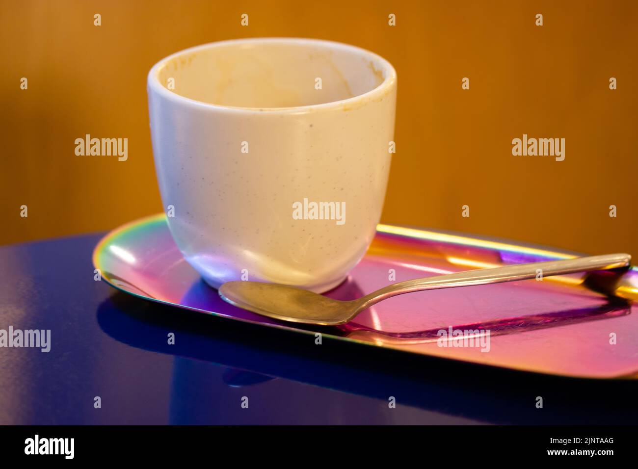 White ceramic cup without handle for cappuccino latte tea stands on ...