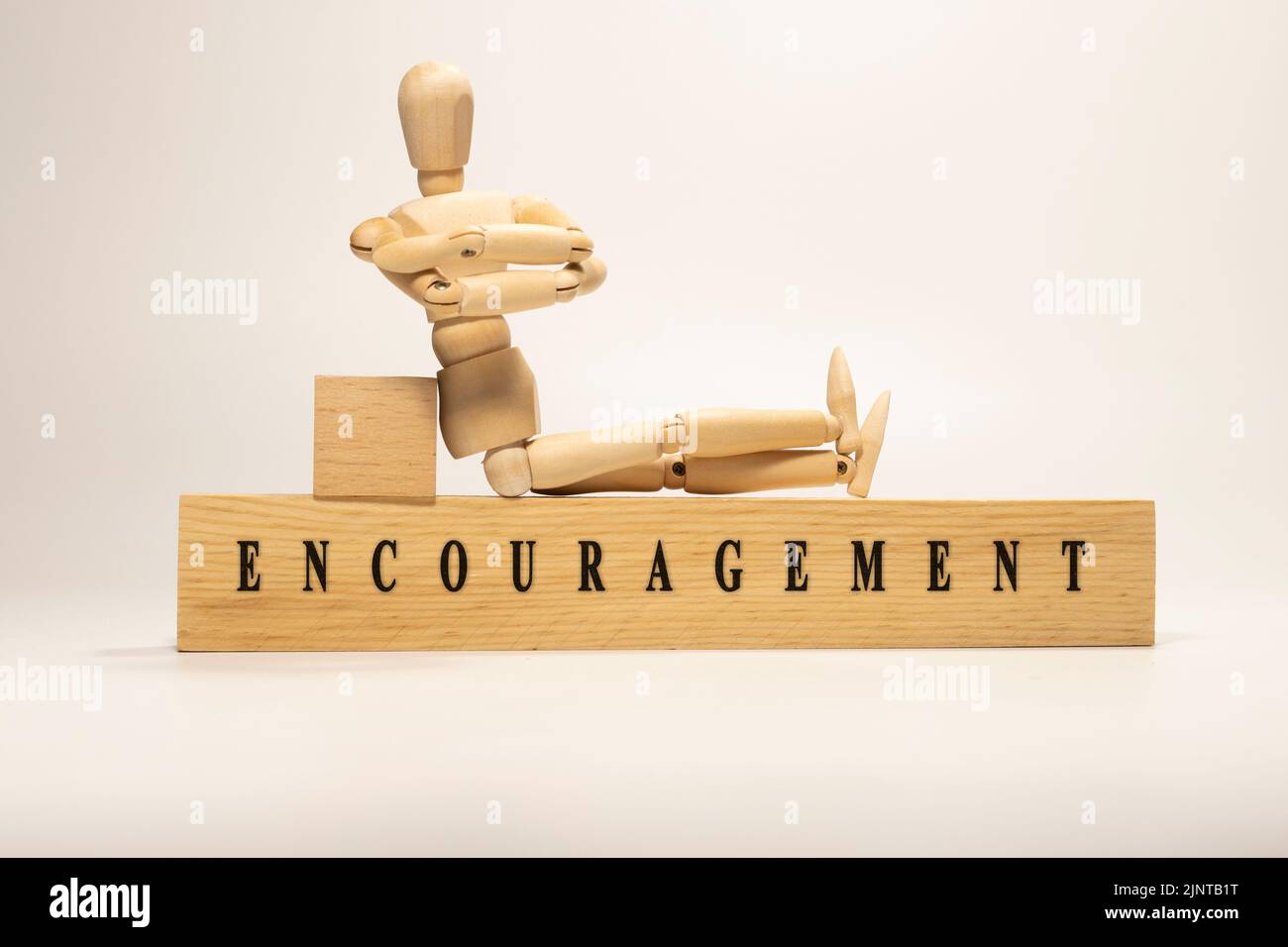 Encouragement written on wooden surface. Motivation and personal ...