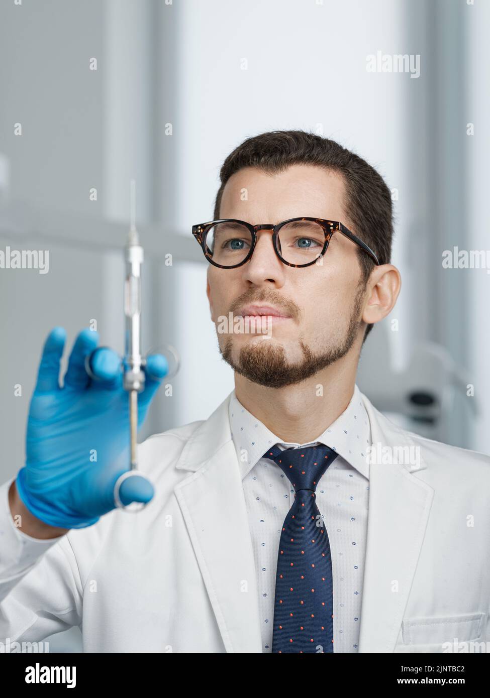 Closeup portrait of male doctor holding cartridge syringe Stock Photo ...