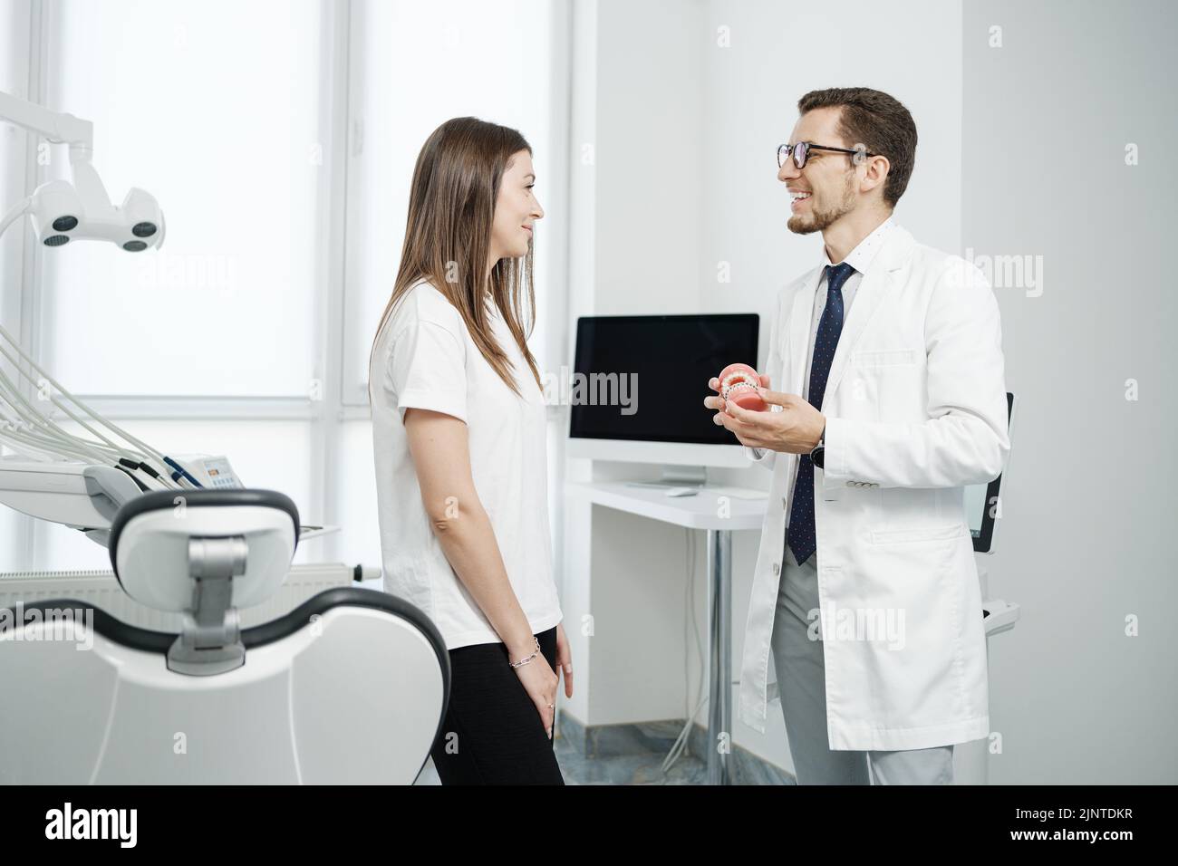 Female patient have a conversation with dentist in dental office Stock ...