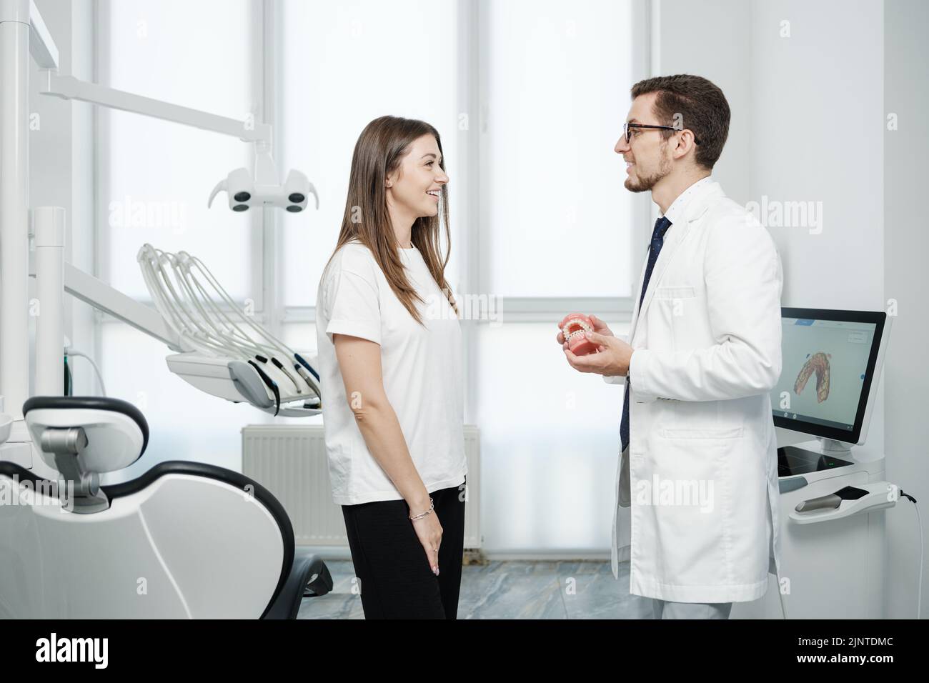 Female patient have a conversation with dentist in dental office Stock ...