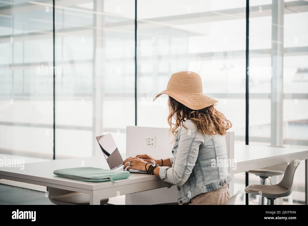 Anonymous woman working on remote project in airport Stock Photo - Alamy
