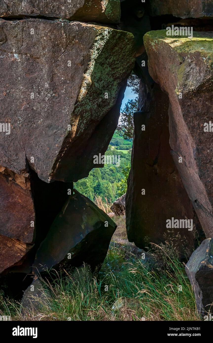 View through a void in the rock in the abandoned quarry face at Dobb ...