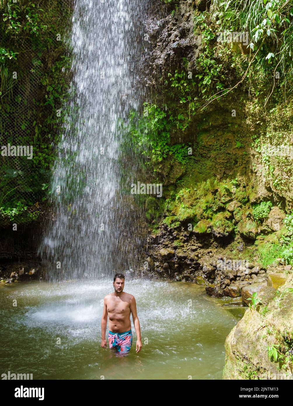 Young men relaxing at Toraille waterfall St Lucia. Saint Lucia jungle ...