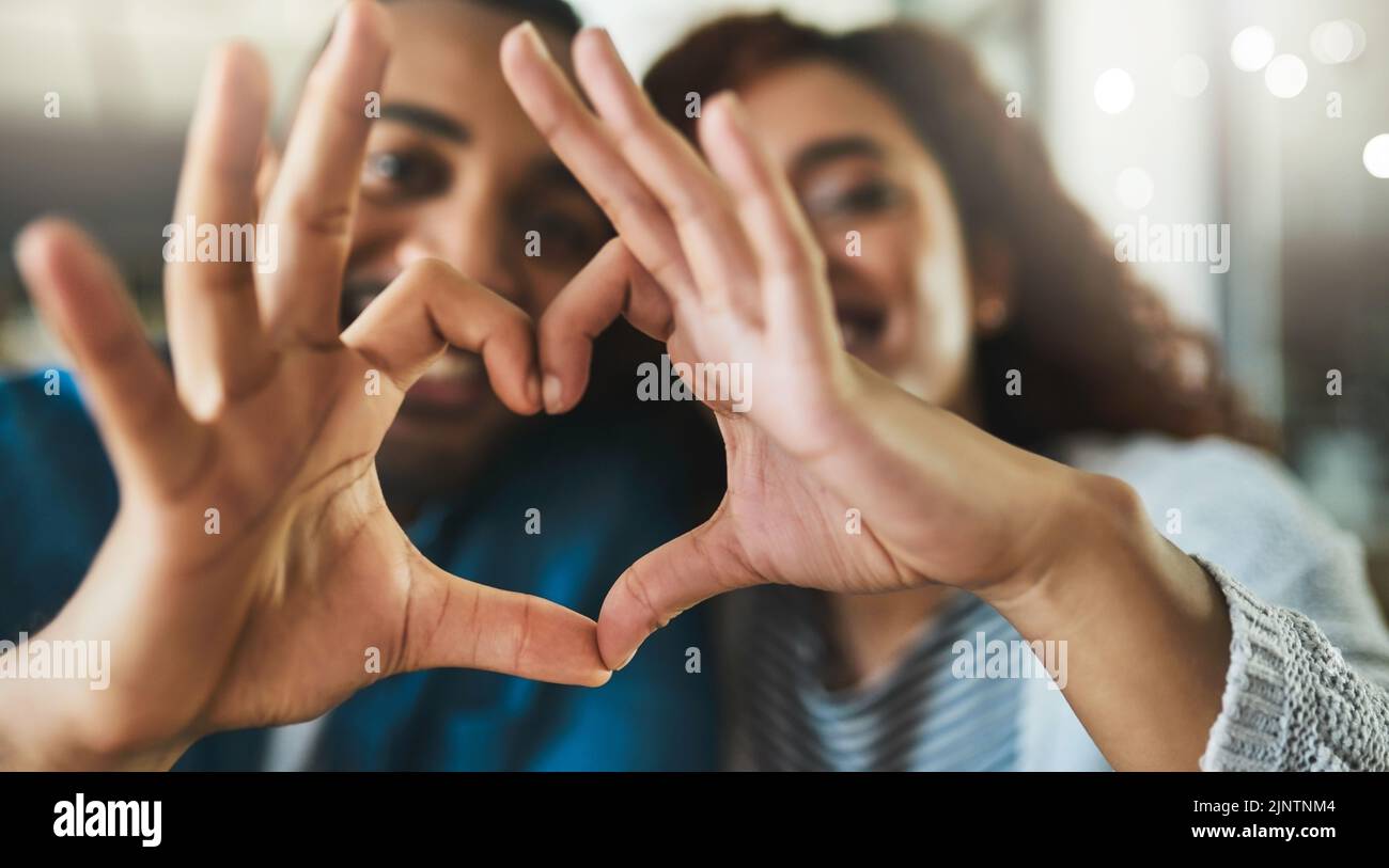 Find that person who completes you. a young couple making a heart ...