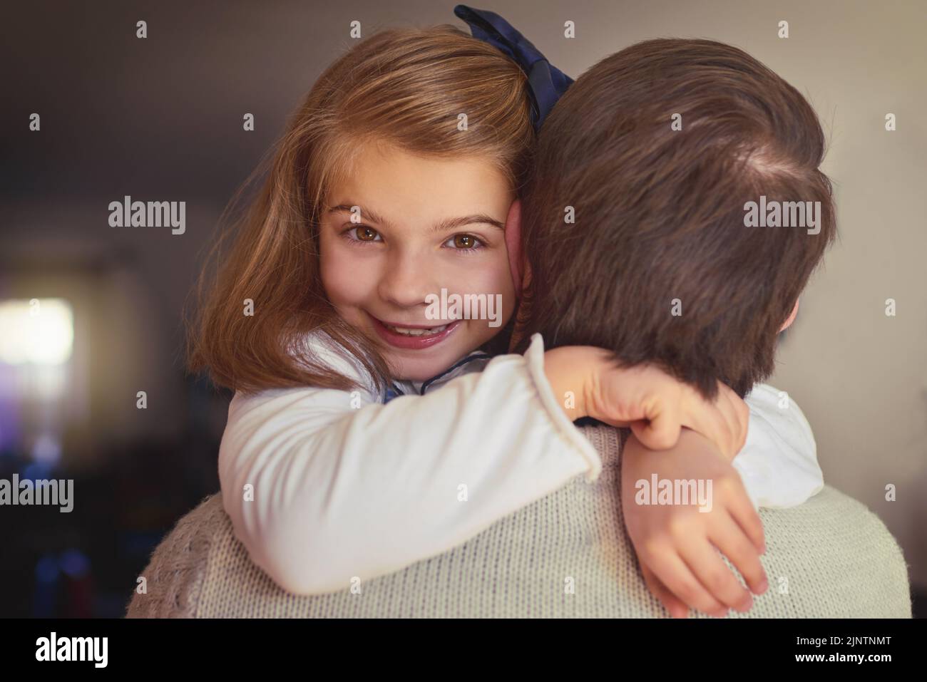 I love my dad. Cropped portrait of an adorable little girl embracing ...