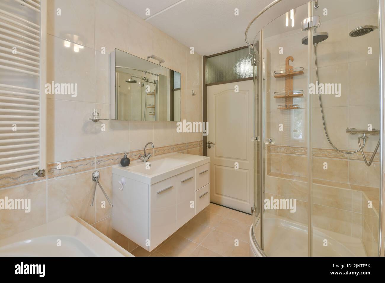 Sinks With Mirrors And Clean Bathtub Located Near Shower Box With Glass