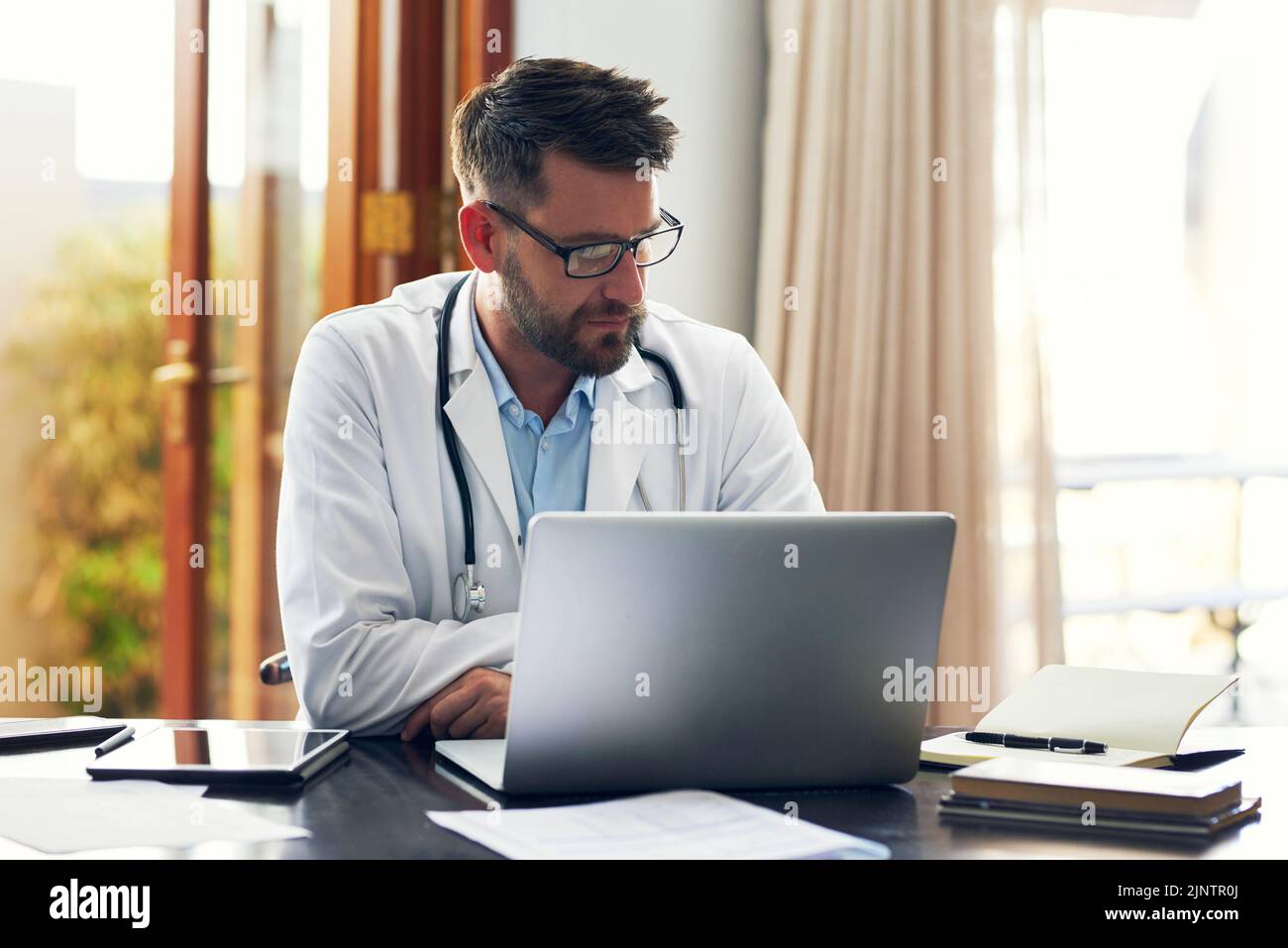 Handsome hospital doctor writing hi-res stock photography and images ...
