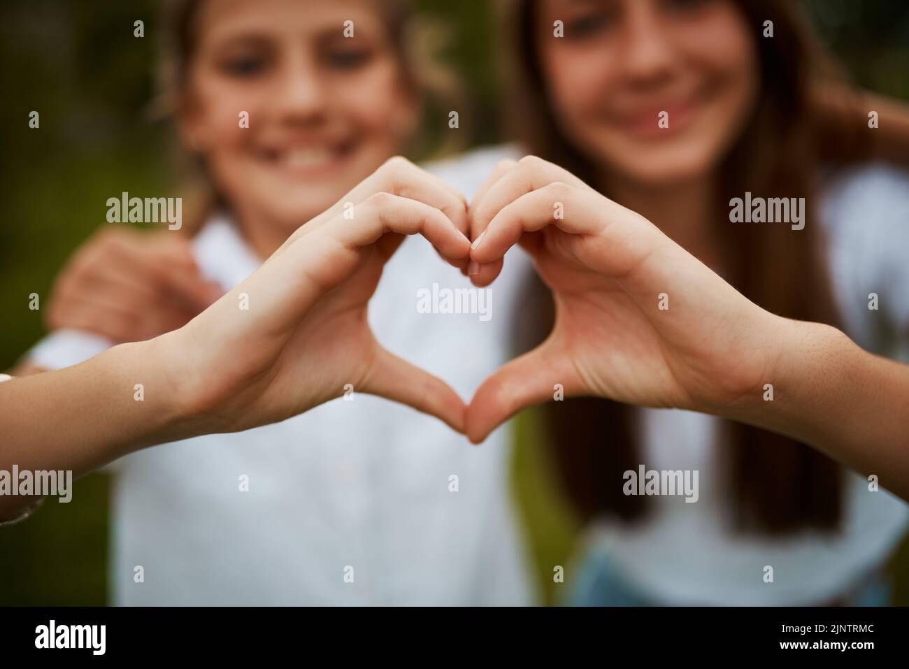 I love my sister. Closeup shot of two young sisters hands making a ...