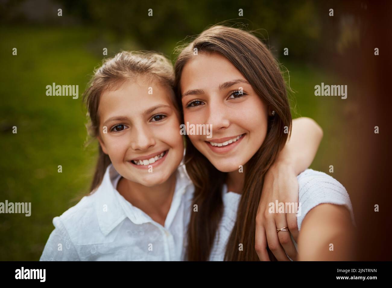 Were As Close As Can Be Cropped Portrait Of Two Young Sisters Taking Selfies In The Park Stock