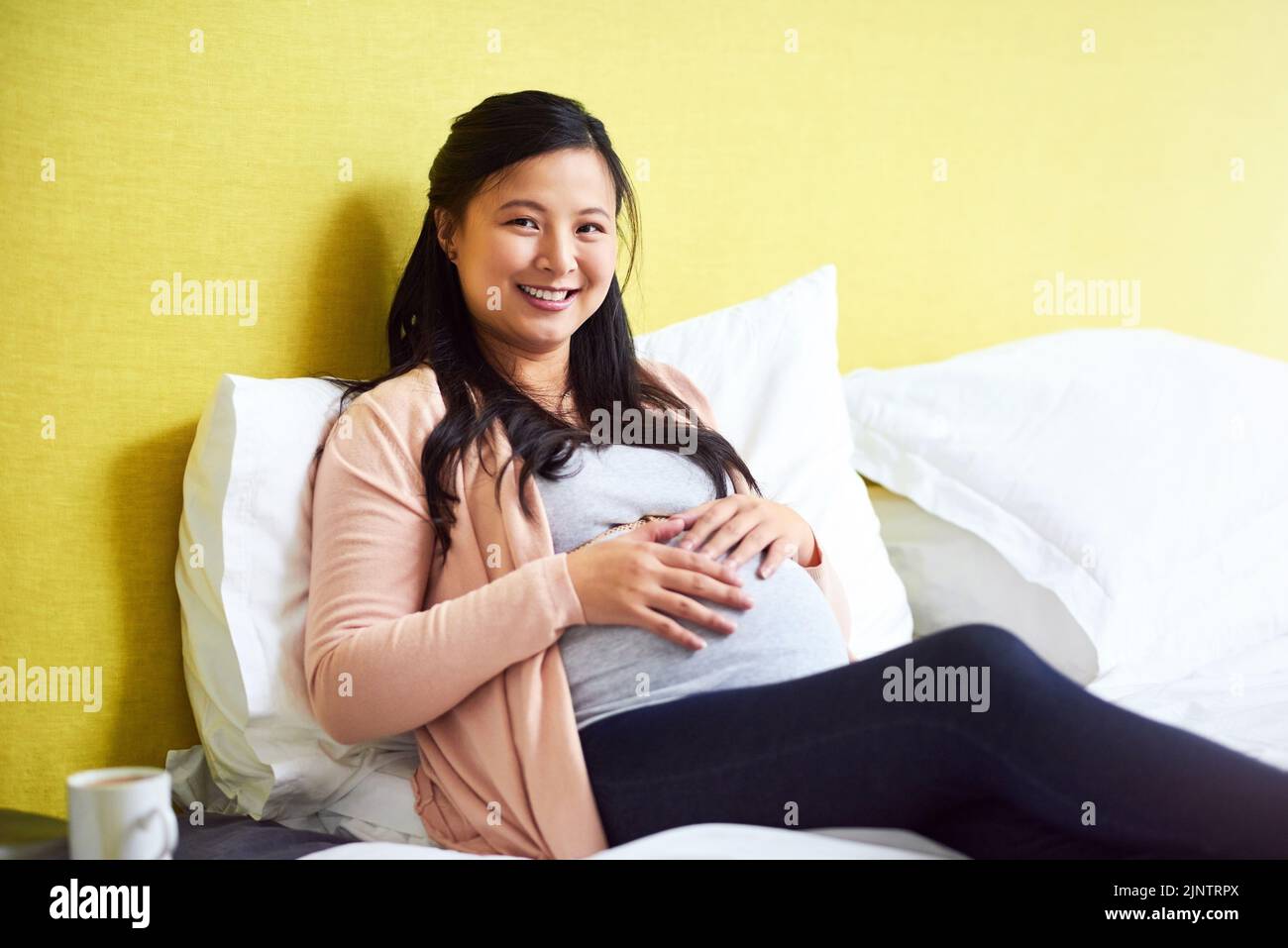 Mommy needs to relax while she can. Portrait of a pregnant woman ...