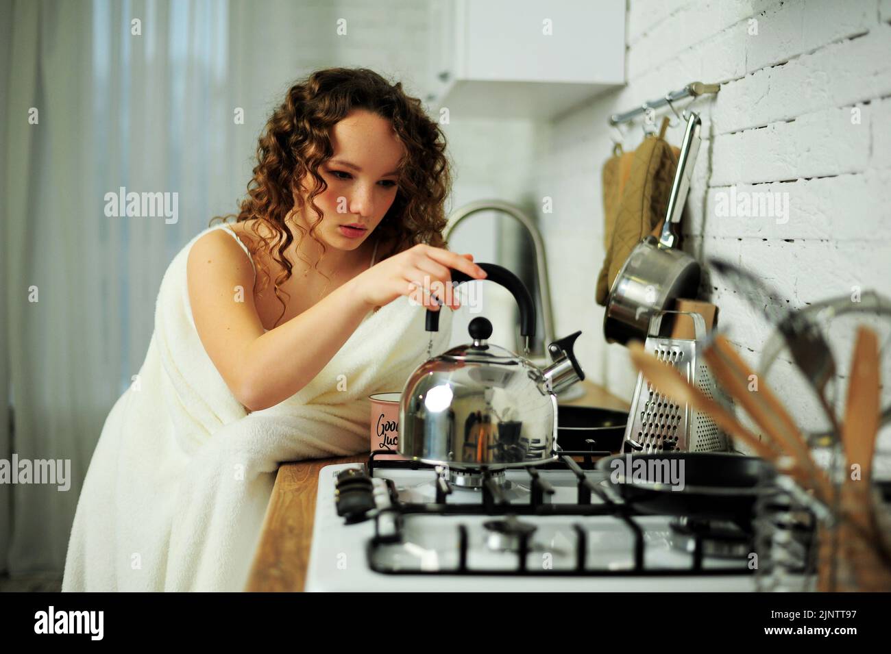teenager girl wanted tea but there is no water in the kettle and she ...