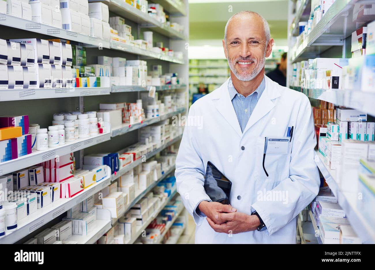 What seems to be ailing you. Portrait of a confident mature pharmacist working in a pharmacy ...