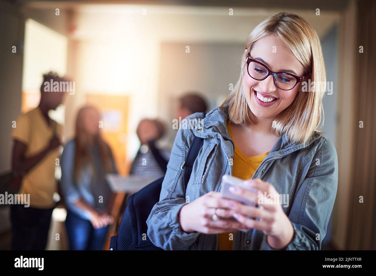 Lets meet up after class. a university student using a cellphone at ...