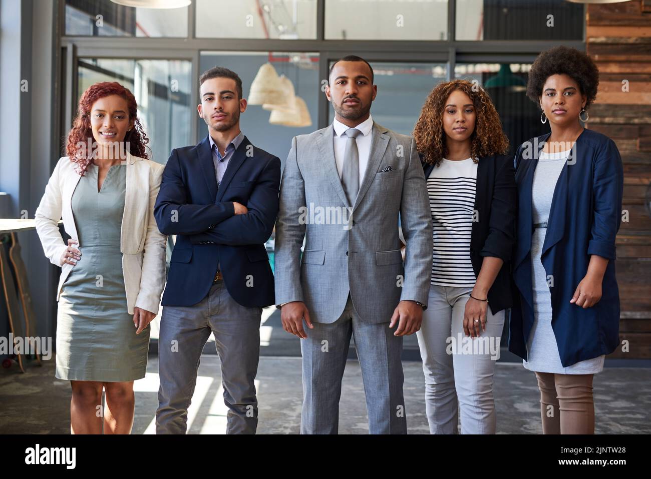 Stand up straight and success in your stride. Portrait of a group of ...