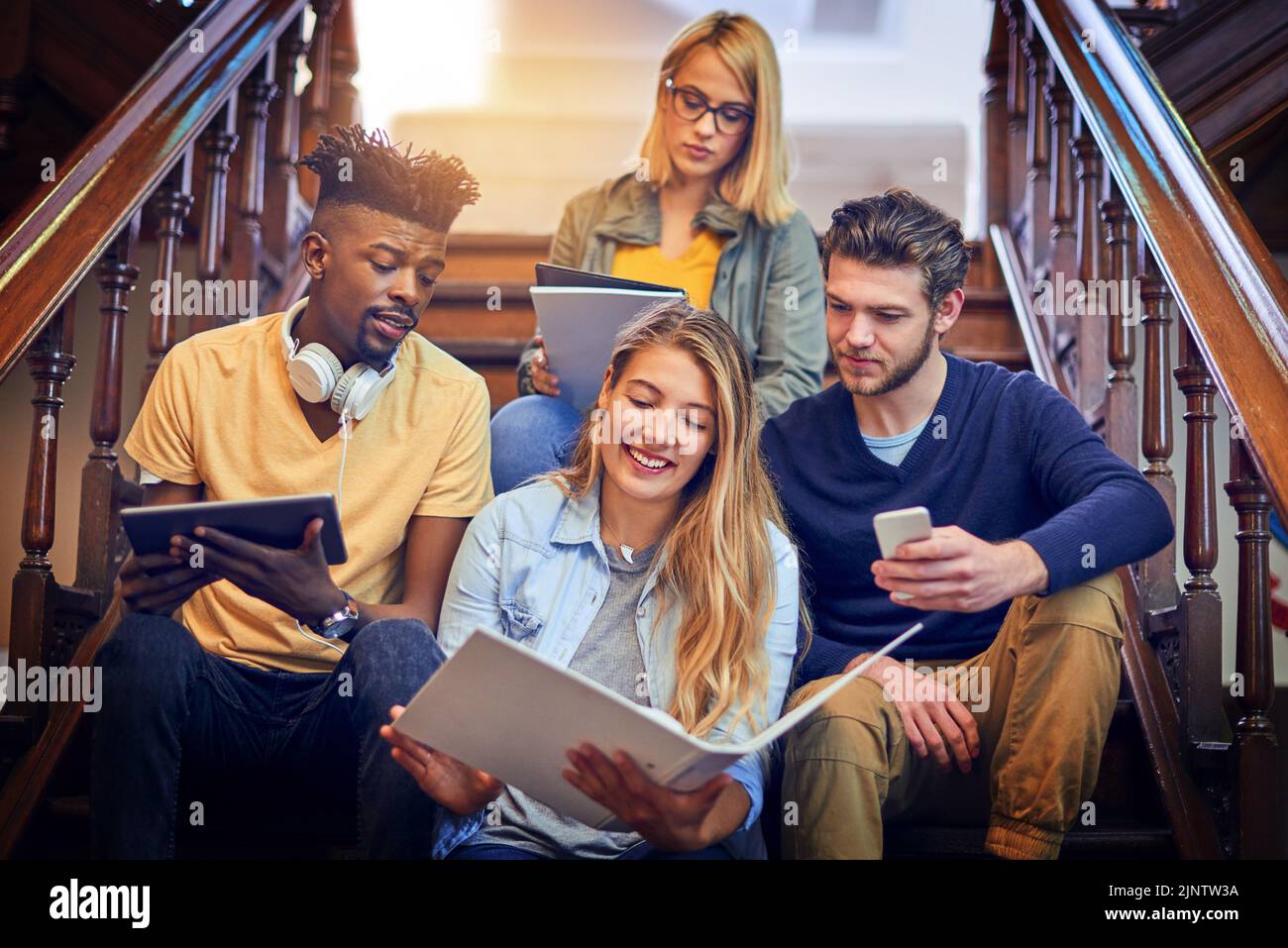 Working on a task together. a group of diverse university students ...