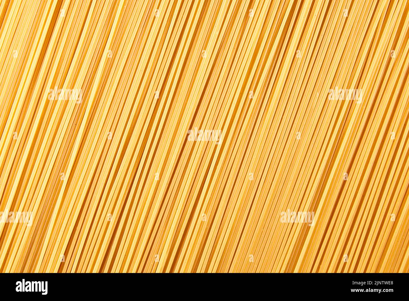 Italian food background, raw spaghetti filling the frame in a textured ...