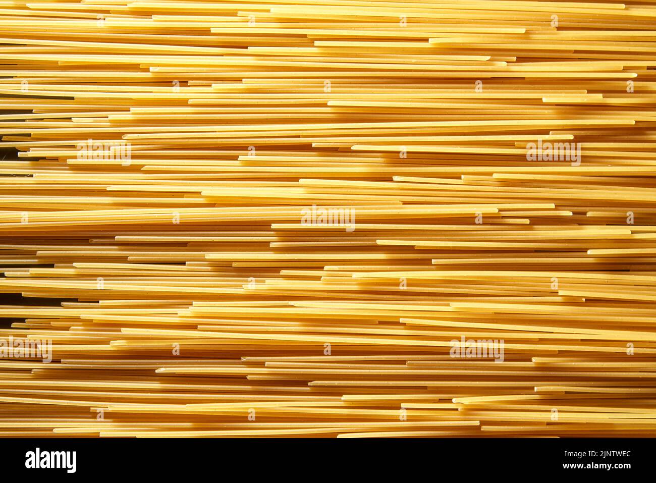 Italian food background, raw spaghetti filling the frame in a creative ...