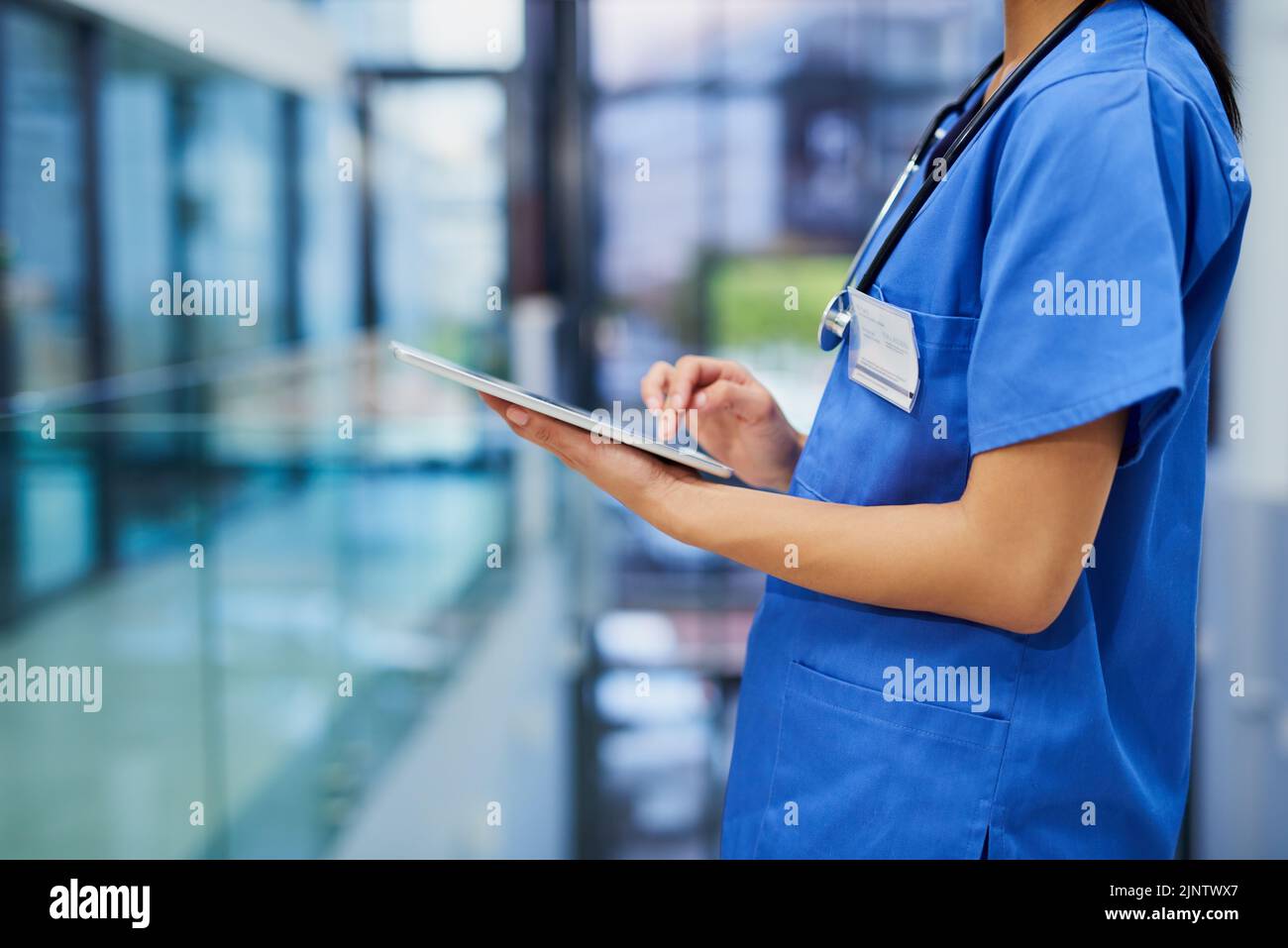 Keeping her medical records up to date. an unrecognizable female nurse ...