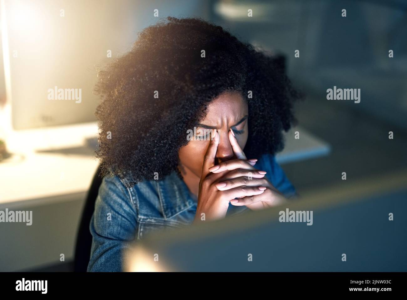 Shes on the late shift... again. a young businesswoman looking stressed ...