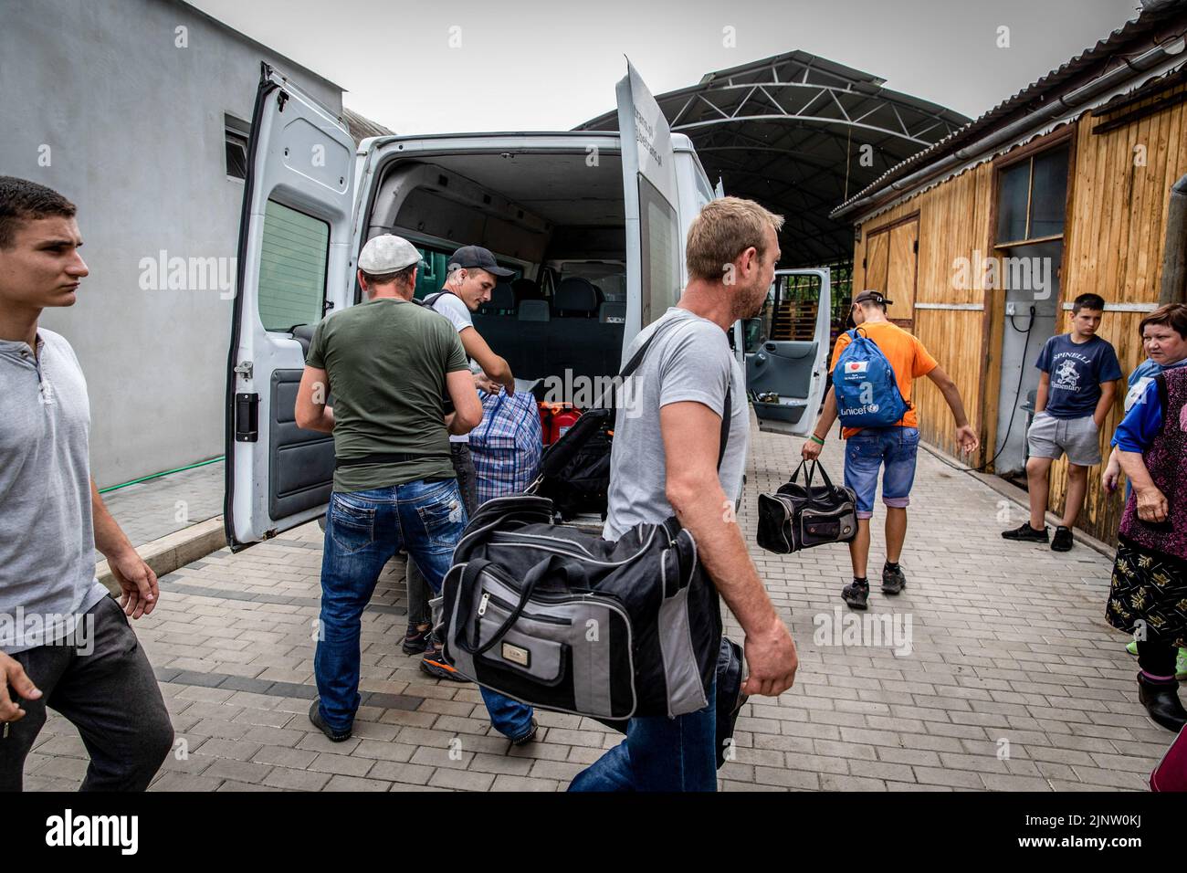 People evacuated seen unloading their luggage from the evacuation ...