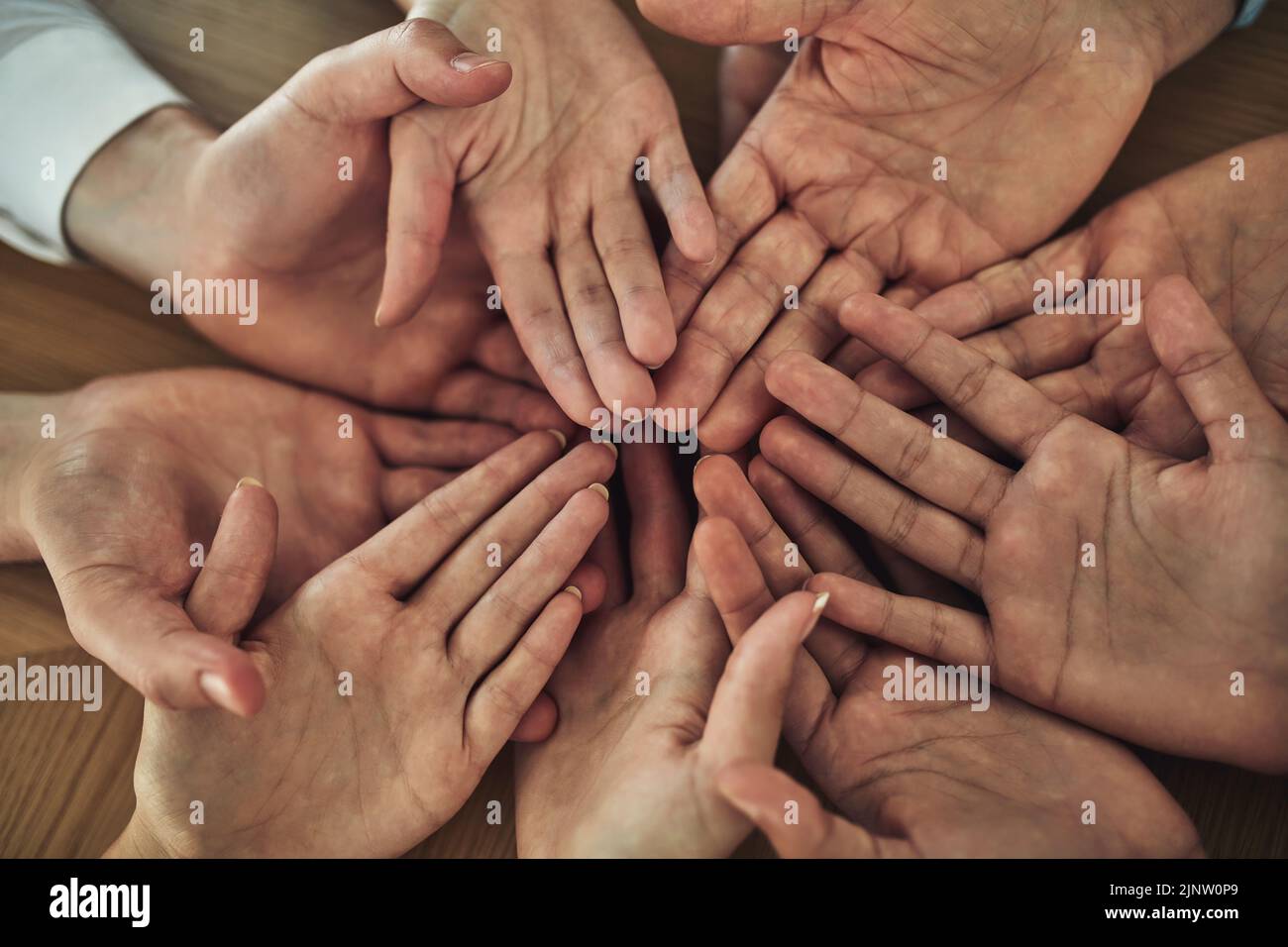 We need a helping hand. a group of businesspeople with their hands ...