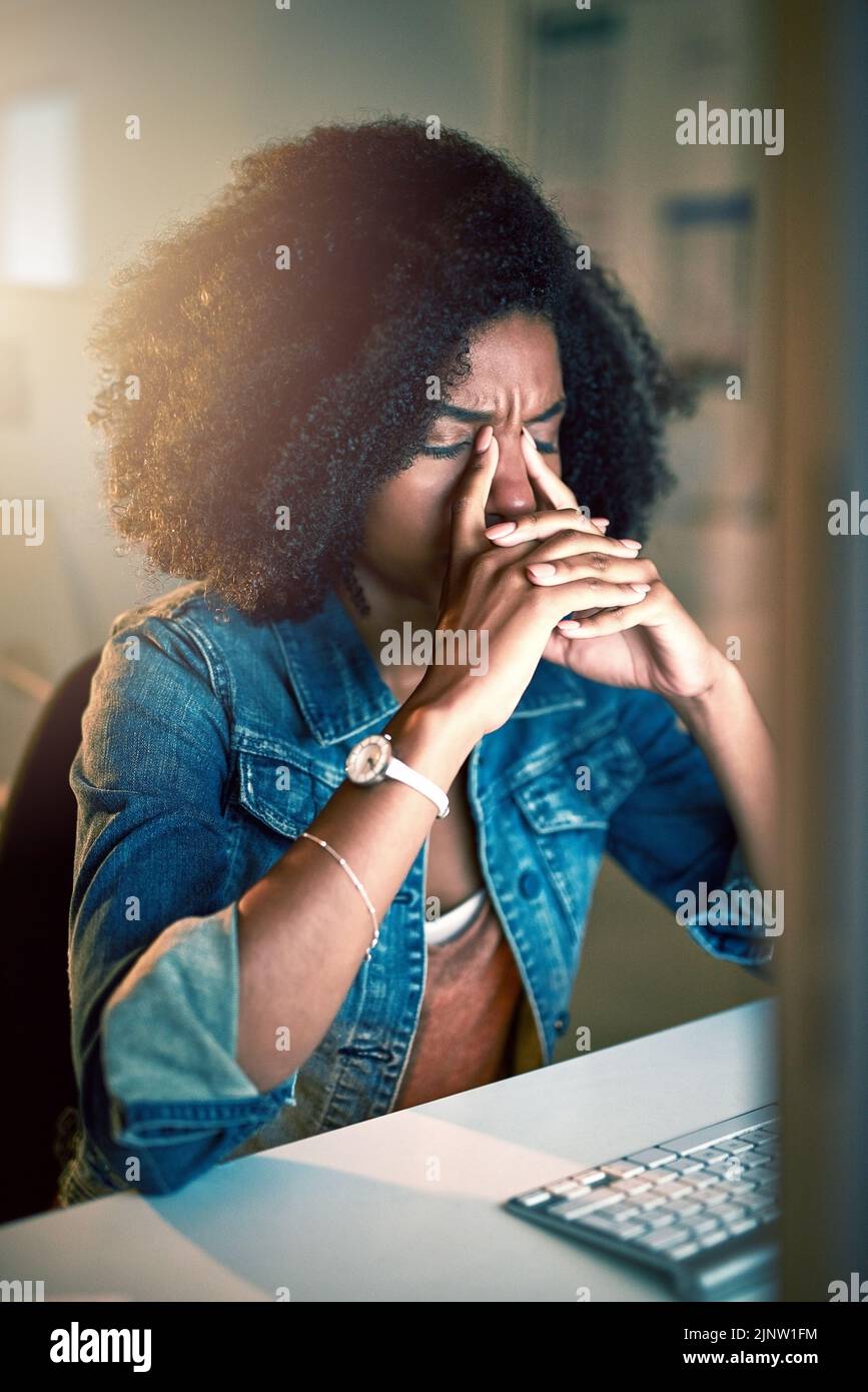 I cant face these late nights any longer. a young businesswoman looking ...