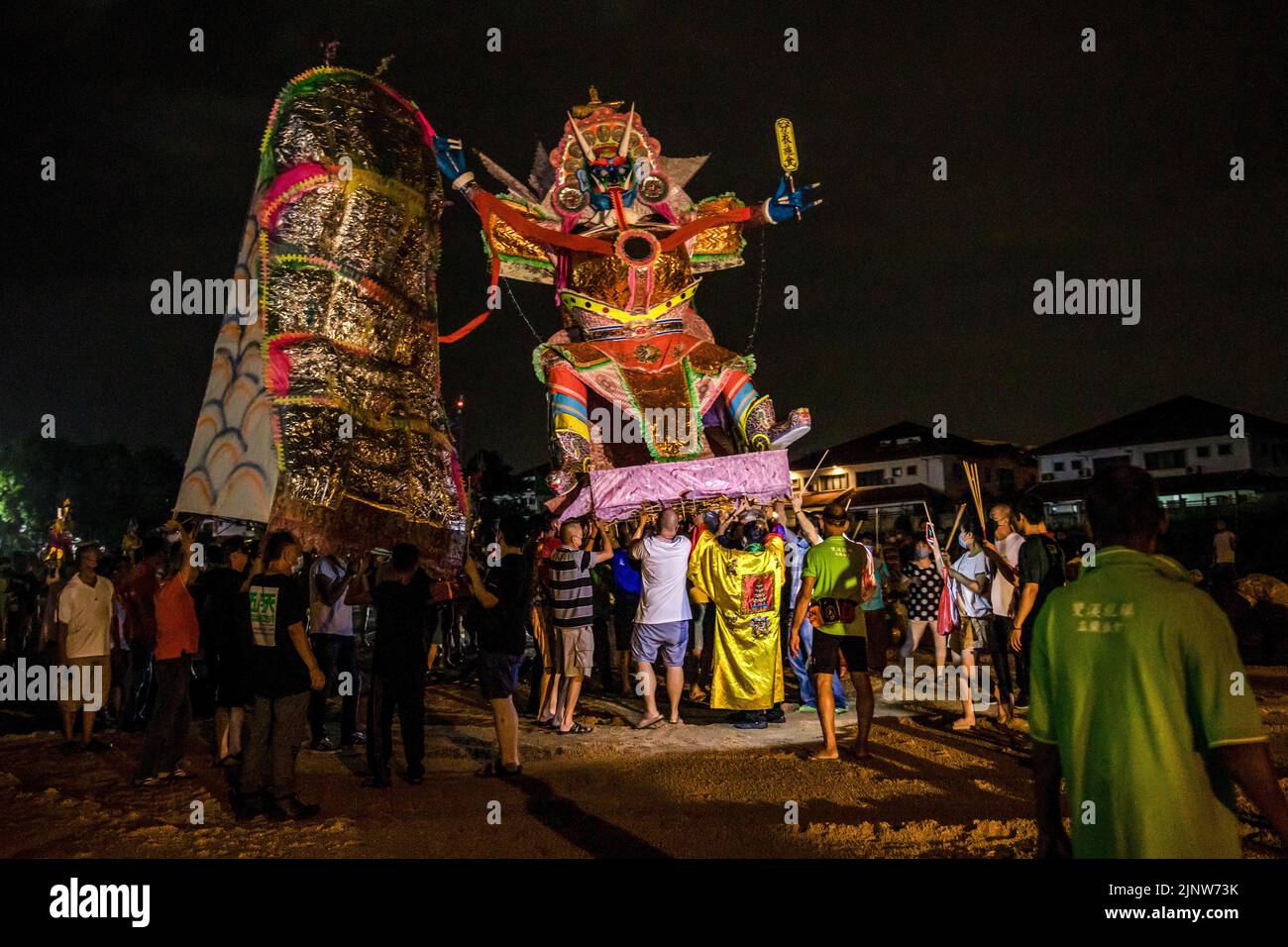 Malaysian Chinese people carry a giant paper statue of the Chinese ...