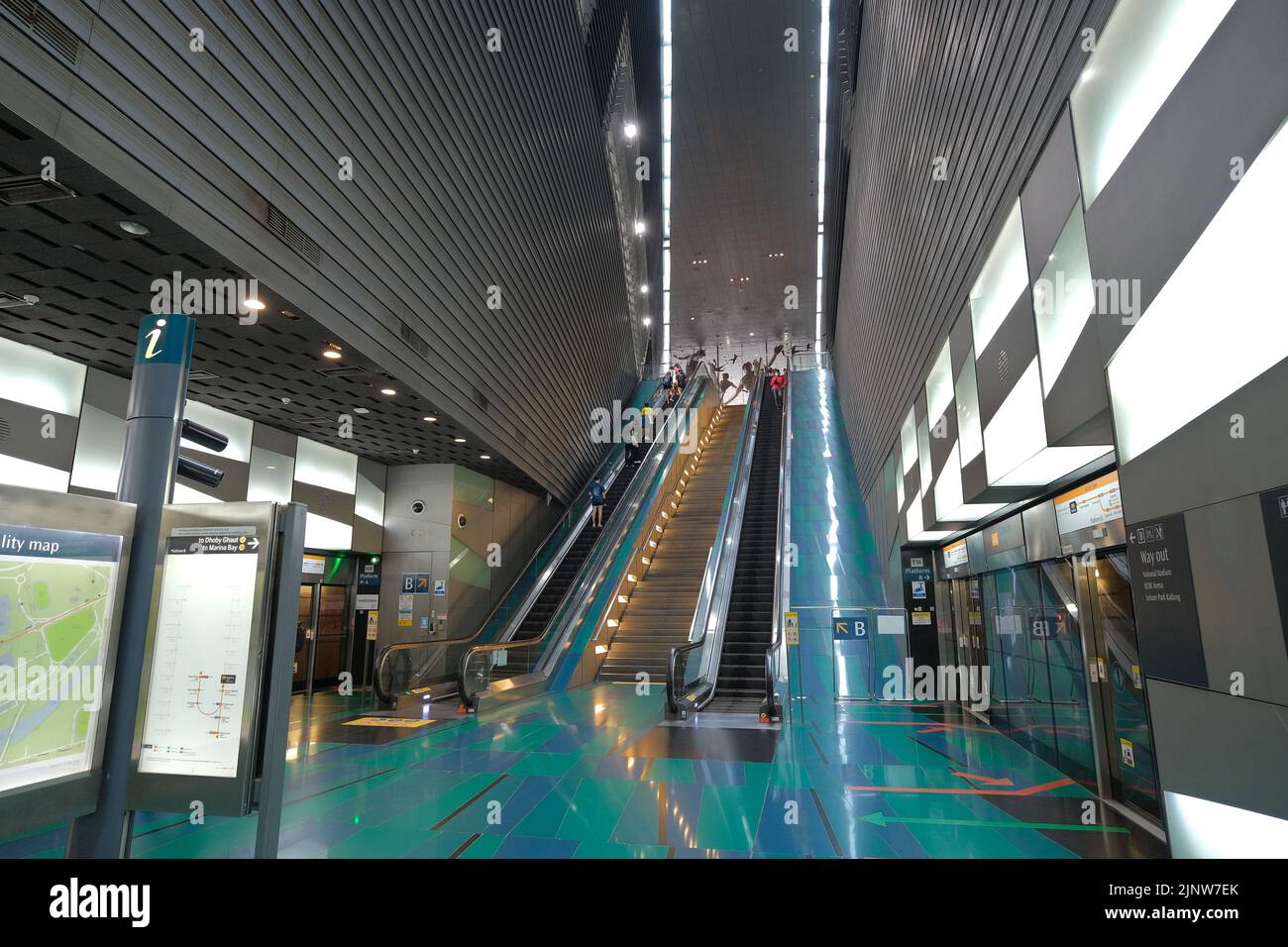 Escalators leading to the platform level of the Stadium MRT Station ...