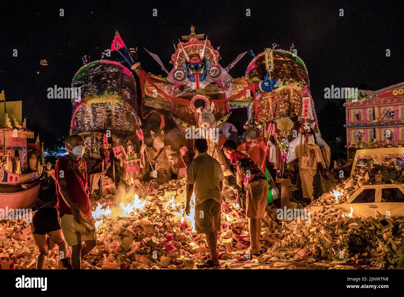 Malaysian Chinese people burn a giant paper statue of the Chinese deity ...