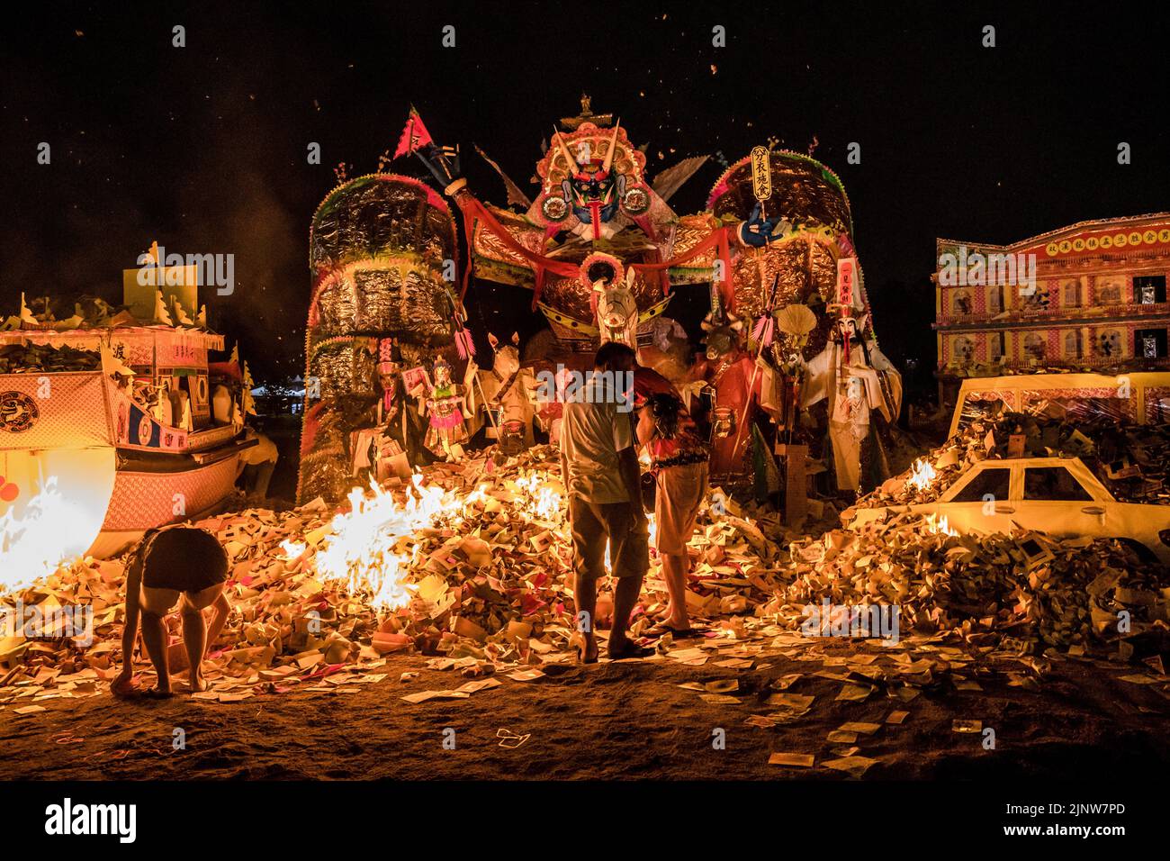 Malaysian Chinese people burn a giant paper statue of the Chinese deity ...