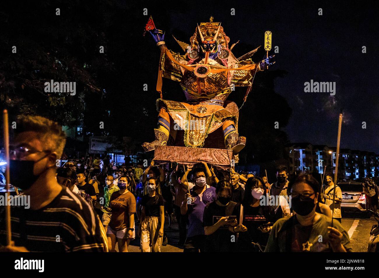 Malaysian Chinese people carry a giant paper statue of the Chinese ...