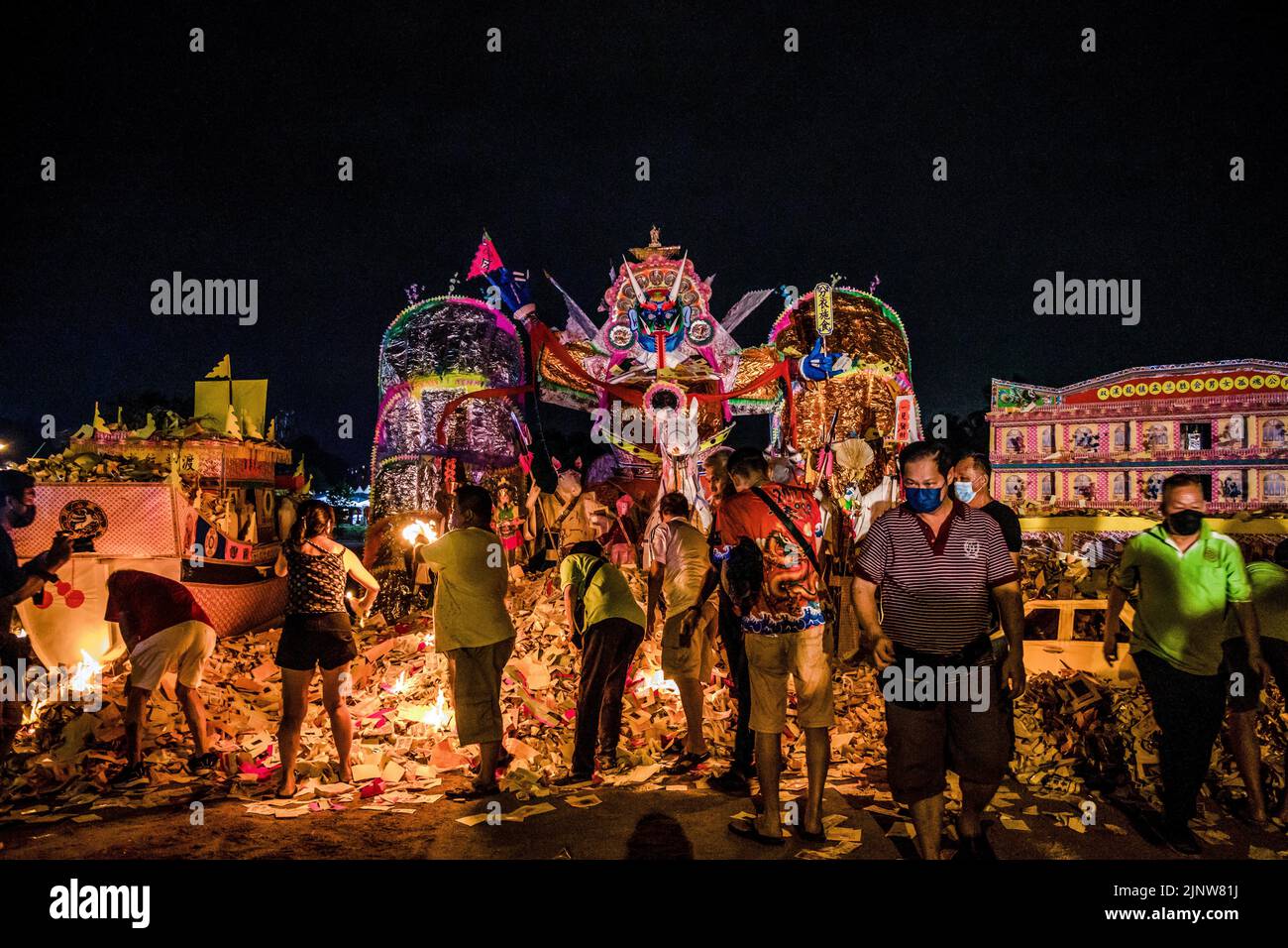 Malaysian Chinese people burn a giant paper statue of the Chinese deity ...