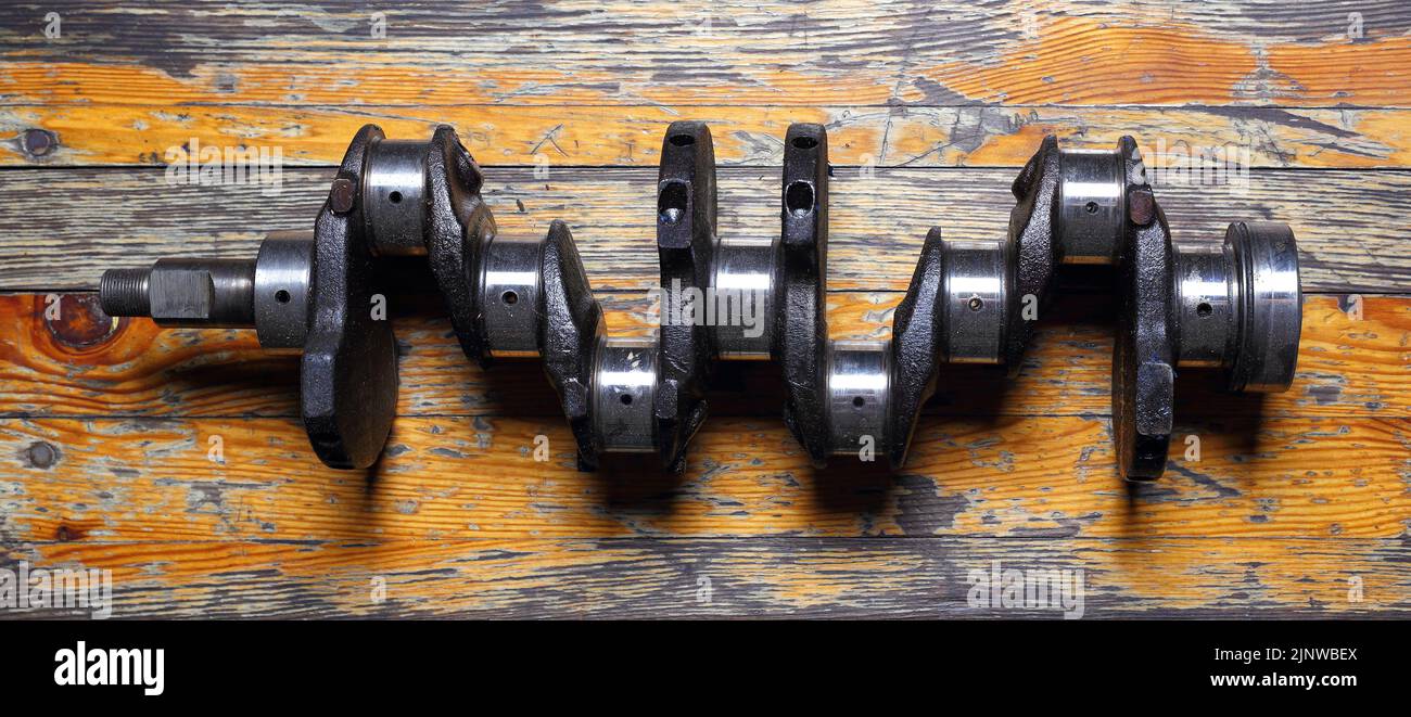 Car Parts - Automobile petrol engine Crankshaft on an wooden background ...
