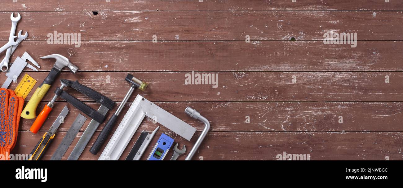 Top view banner tools building and repair set on a wooden background ...