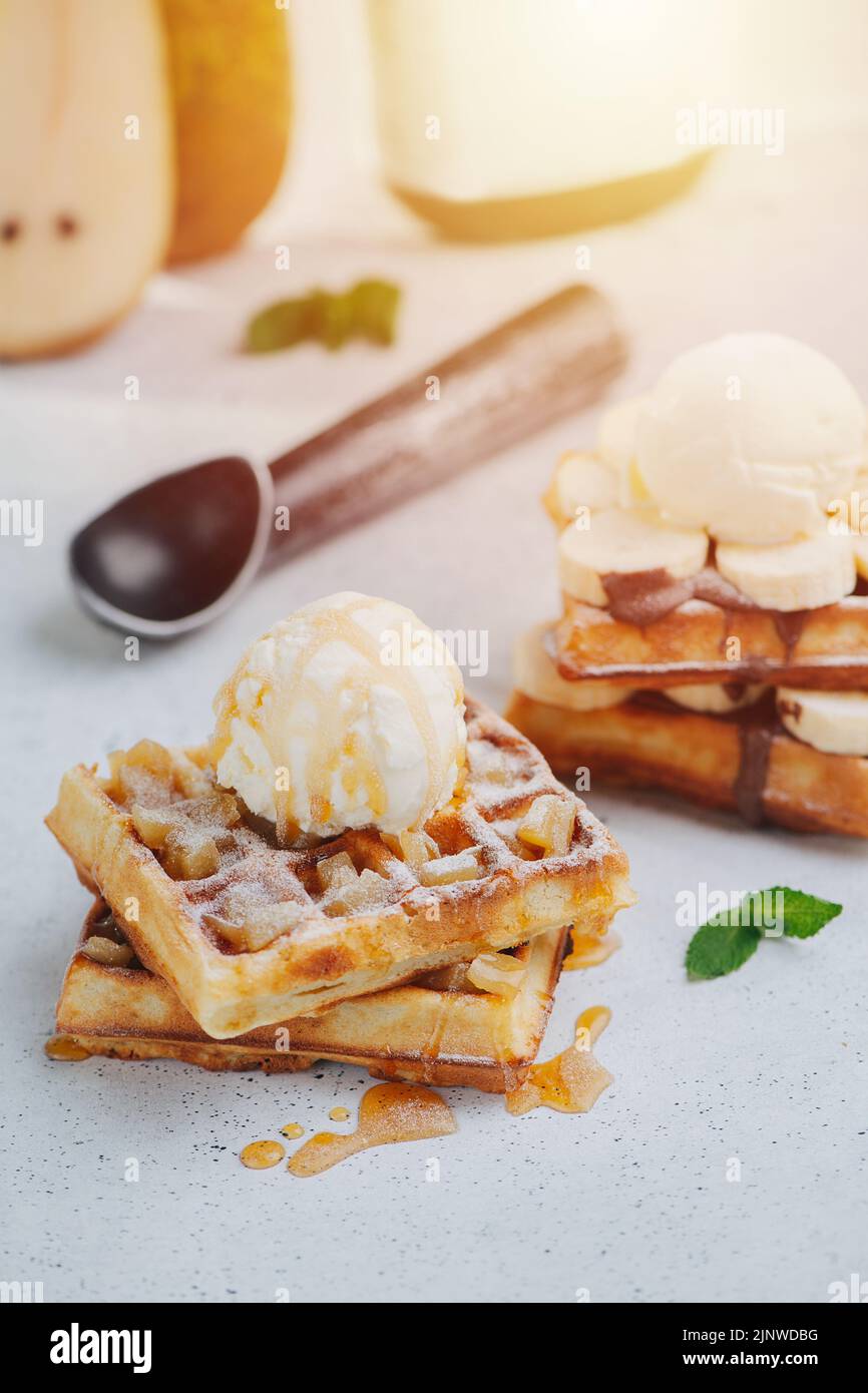 Sunlit image of waffles topped with chocolate paste, banana slices and ...