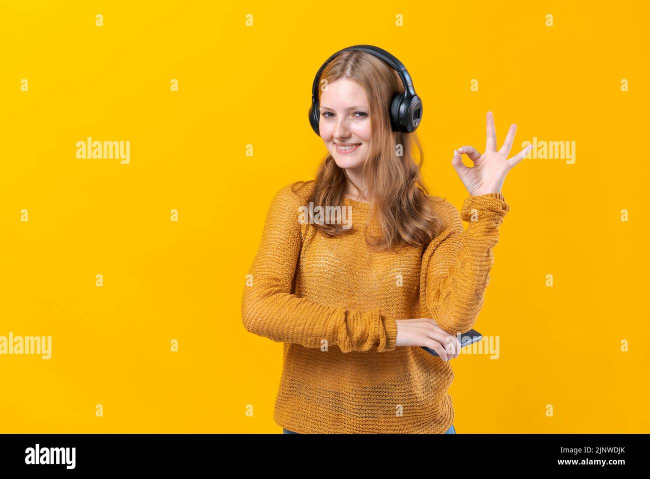 Image of emotional happy excited young woman listening to music with ...