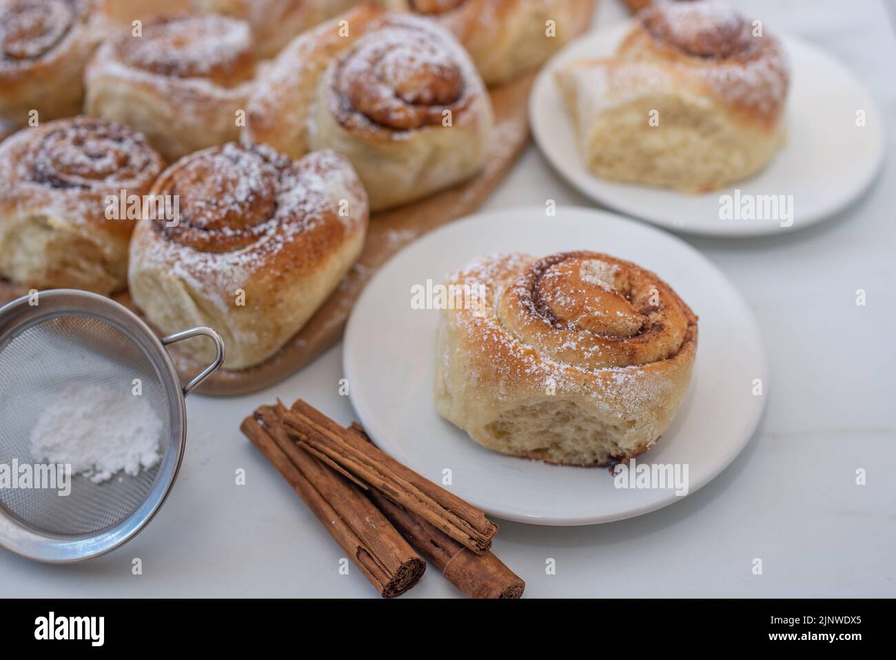 sweet home made cinnamon roll buns on a table Stock Photo - Alamy