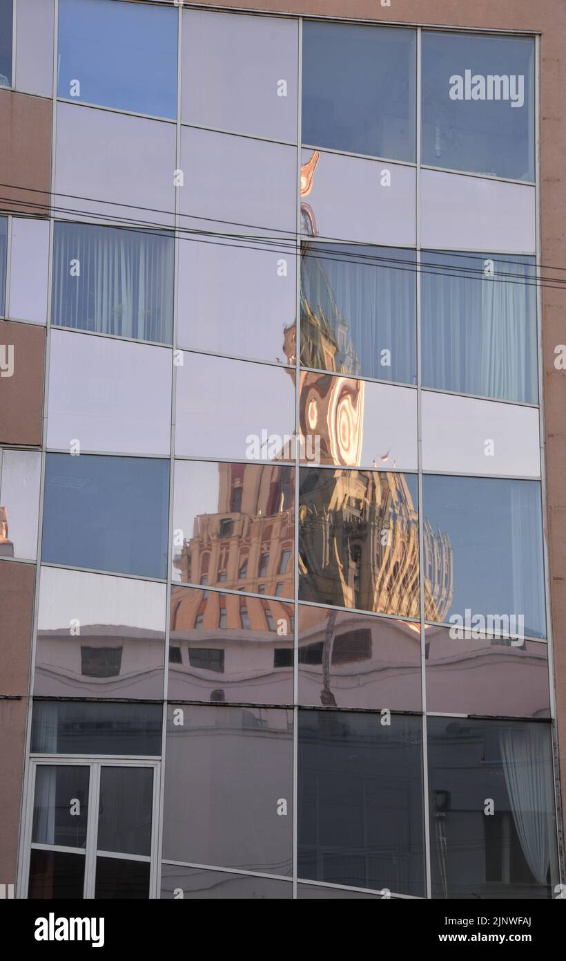The twisted image of a tower on the mirror Stock Photo - Alamy