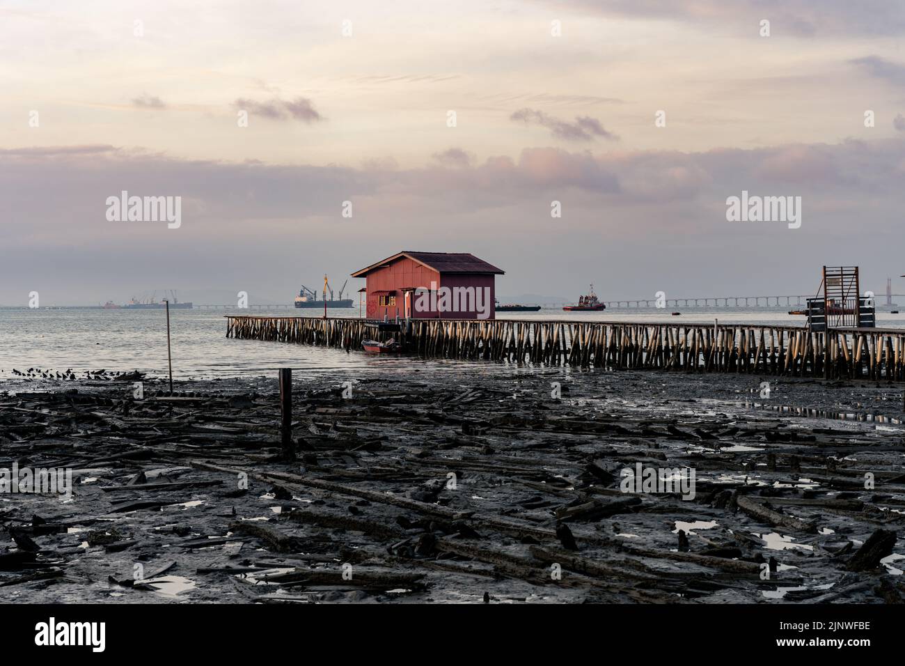 Sunrise view of wooden bridge and red house background at Clan Tan ...
