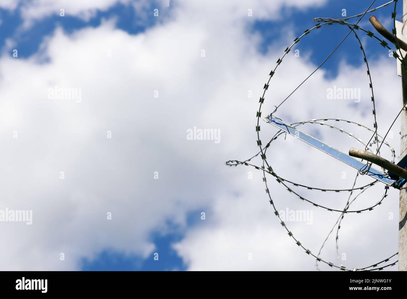 Barbed wire on blue sky background. Concept of boundary, prison or ...