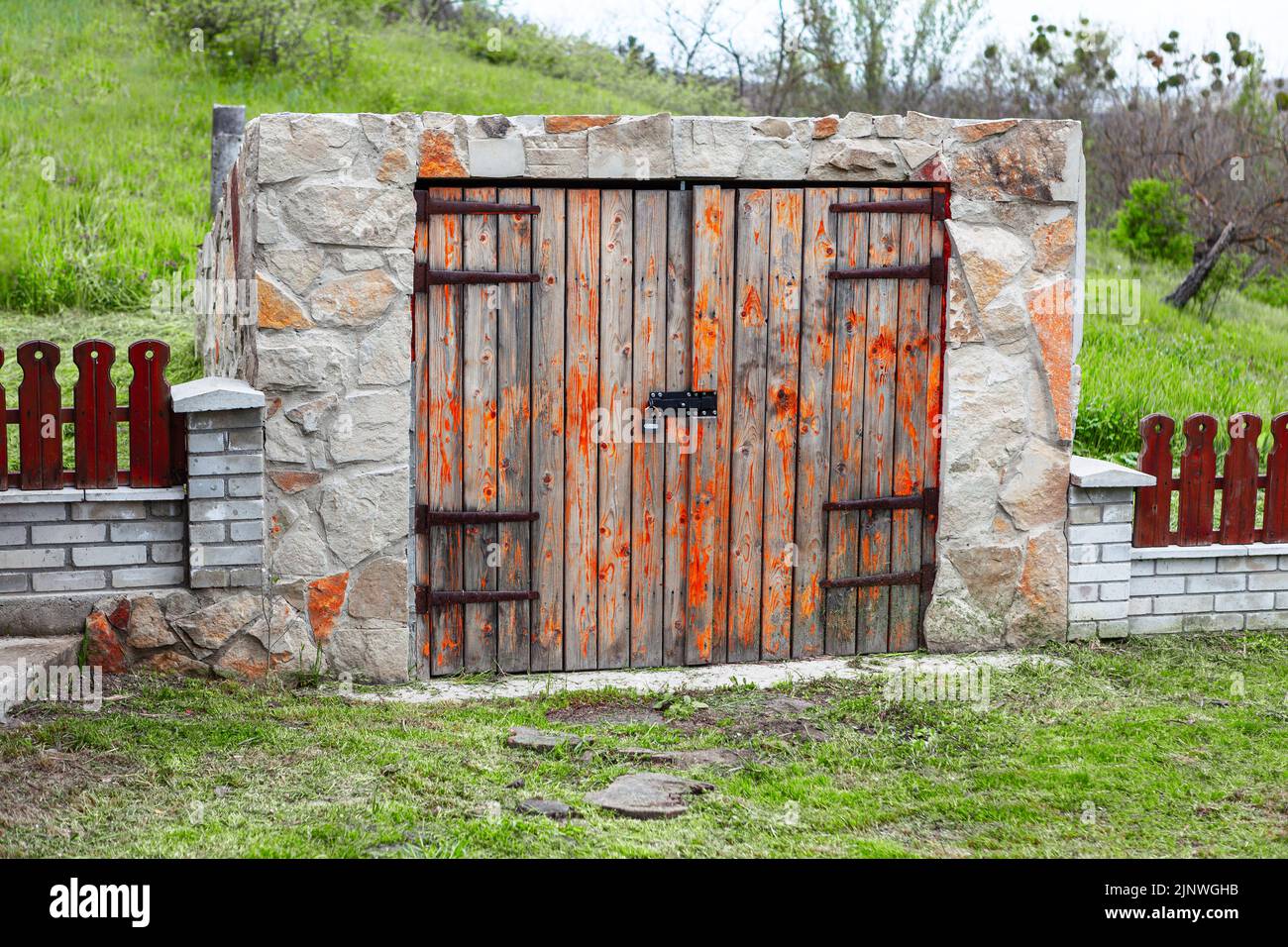 Wine underground cellar . Rustic cellar with wooden gates Stock Photo ...