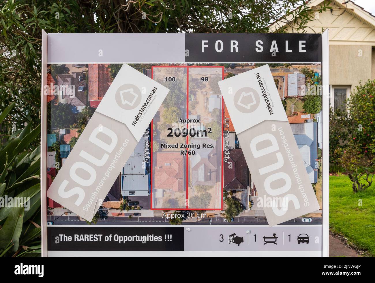 For sale sign on Australian house with sold sticker Stock Photo - Alamy