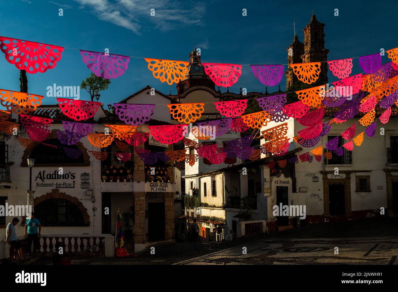 Pecked paper flags are hung over the colonial plaza during the Day of ...