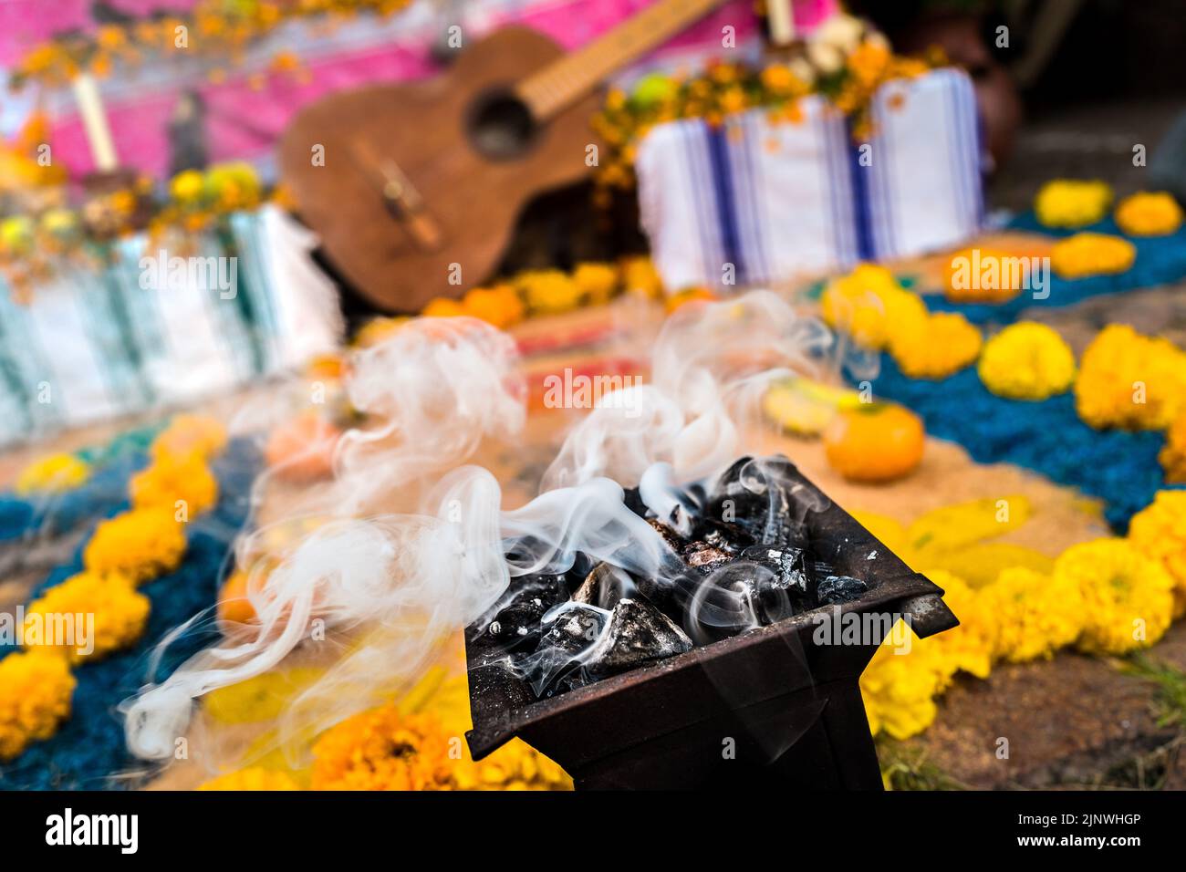 An incense burner is seen smoking at the altar of the dead during the ...