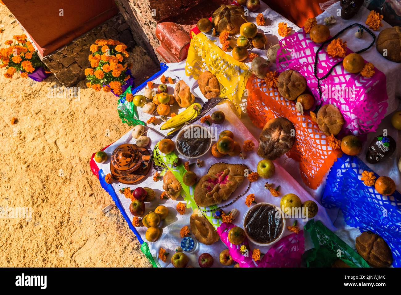 Food offerings are placed at the altar of the dead, a religious site ...