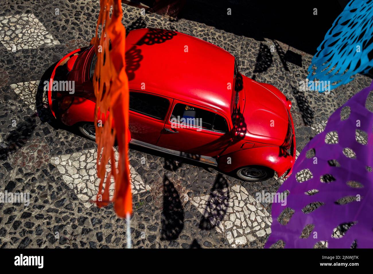 Pecked paper flags are hung over the street during the Day of the Dead ...