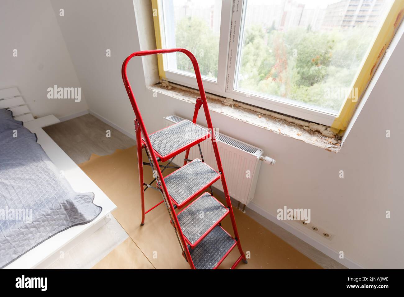 Installation of windows. Polyurethane foam on the slope of the window ...