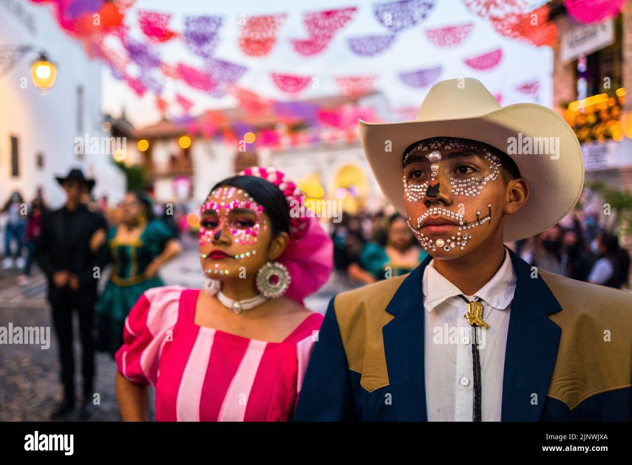 A young Mexican couple, both wearing face jewels makeup, takes part in ...